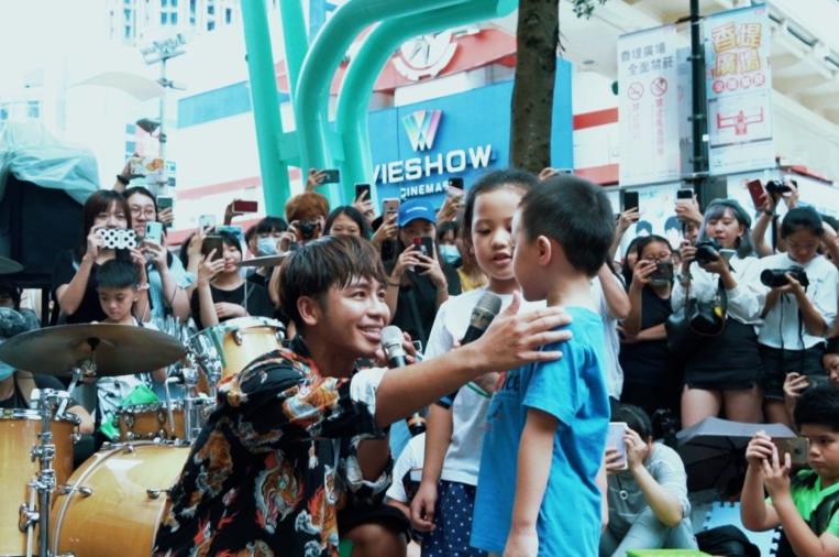 Drumming Lu Siwei on the street with street artist Li Keying double ...
